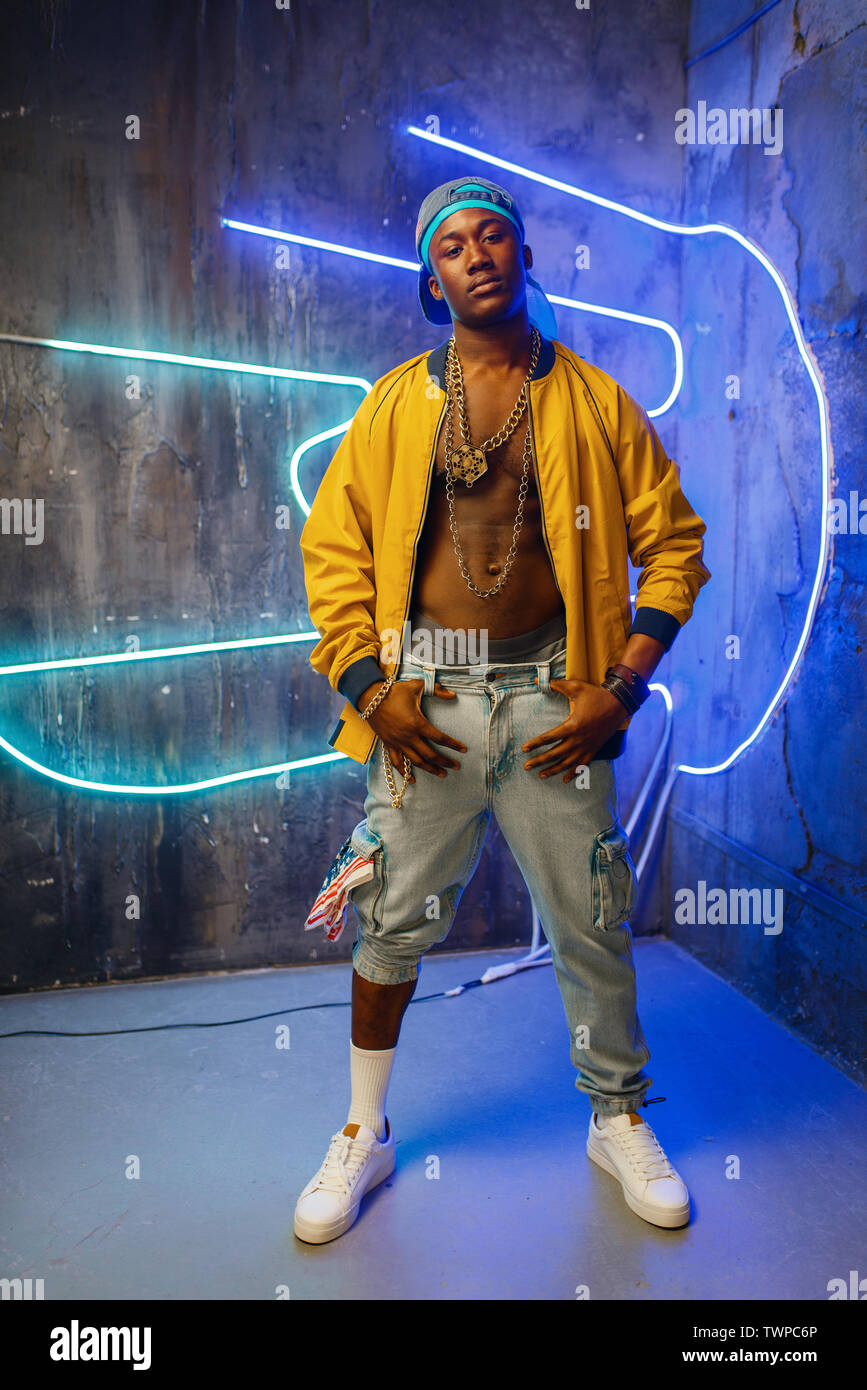 Black rapper in underpass neon light on background Stock Photo - Alamy