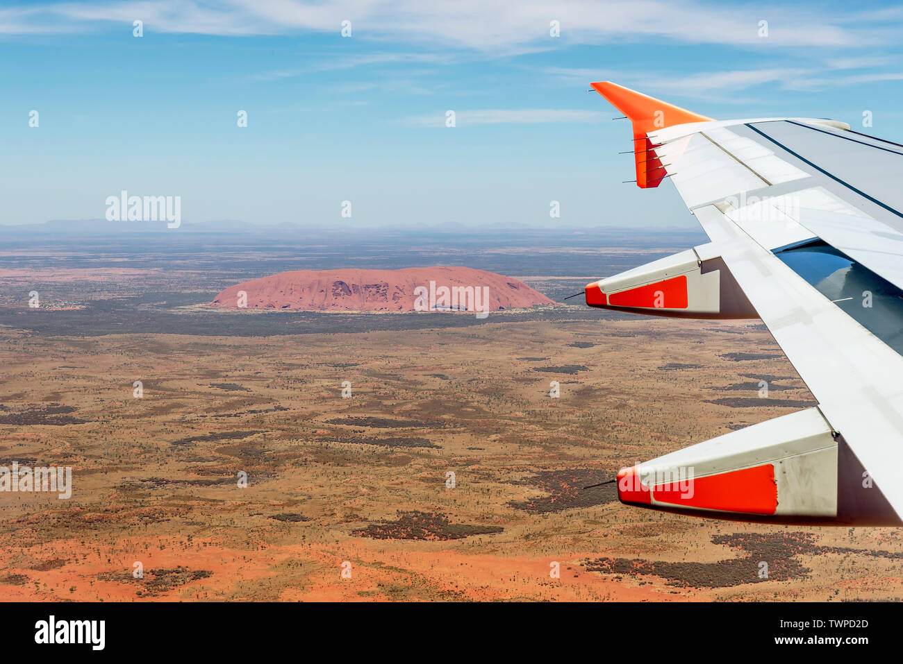Flying over the beautiful Australian outback and Uluru on a warm sunny ...