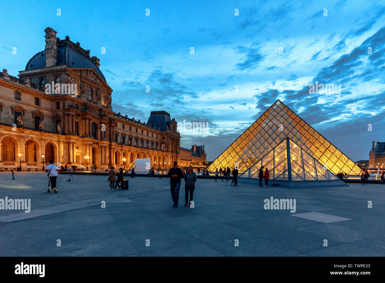 The illuminated glass pyramid at the Louvre Museum in Paris, France at ...