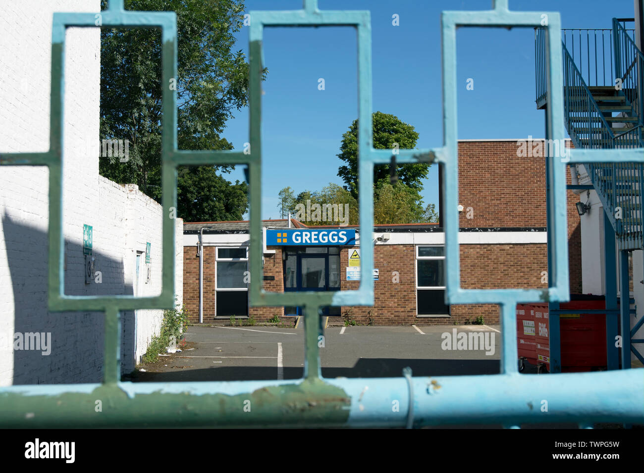 seen through a closed gate, a former greggs bakery site in twickenham ...