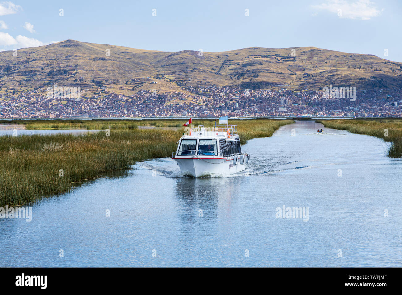 Boating through the reeds and floating villages of Uros islands on Lake ...