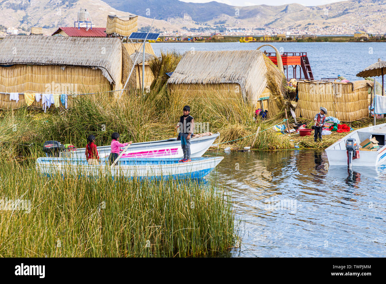 Boating through the reeds and floating villages of Uros islands on Lake ...