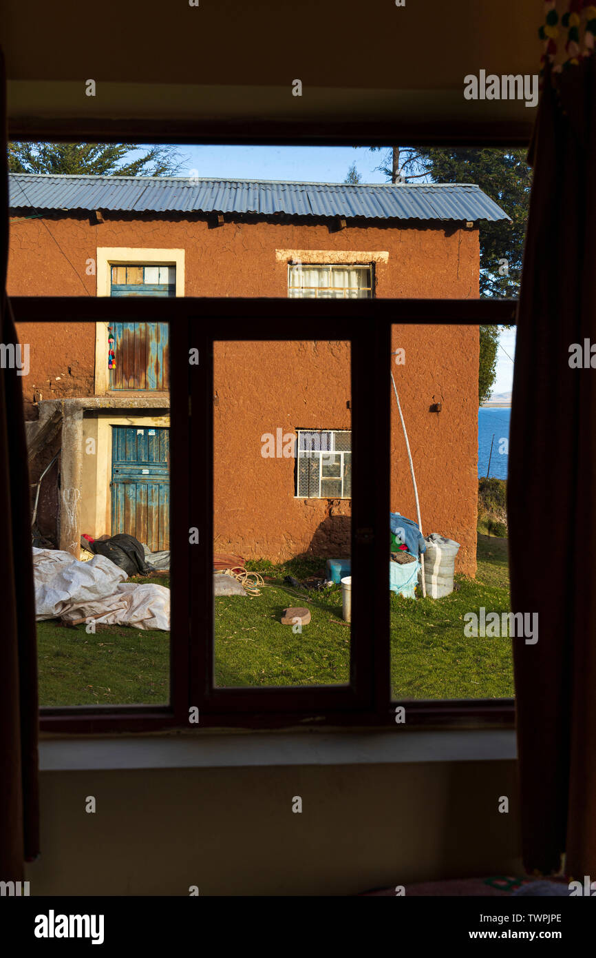 Adobe mud built house seen through a window in Luquina Chico, Lake ...