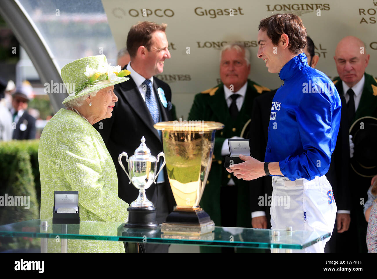 Queen Elizabeth II presents a trophy to jockey James Doyle after Blue ...