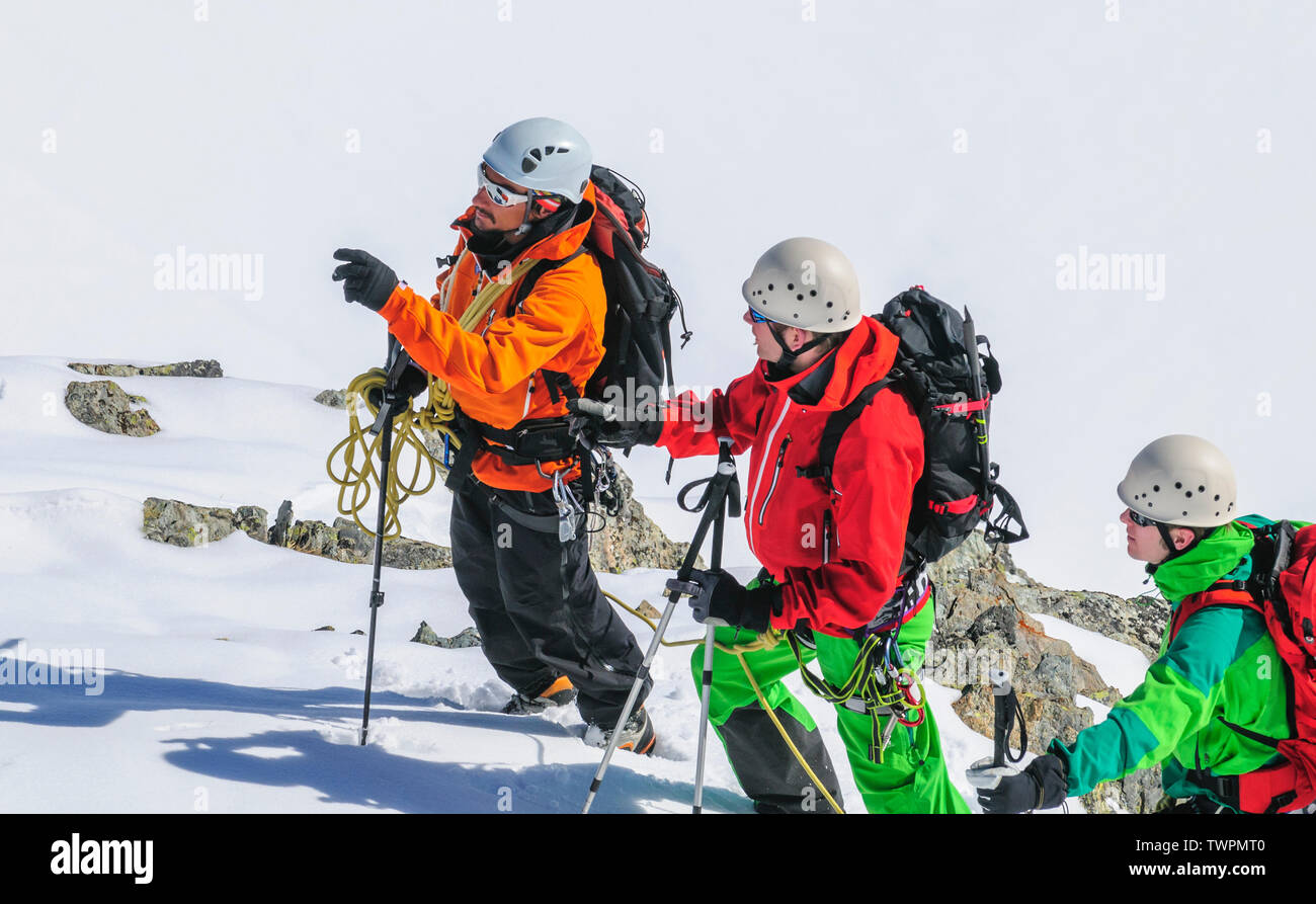 Mountain guide leading a group of alpinists up to Monte Rosa Glaciers ...