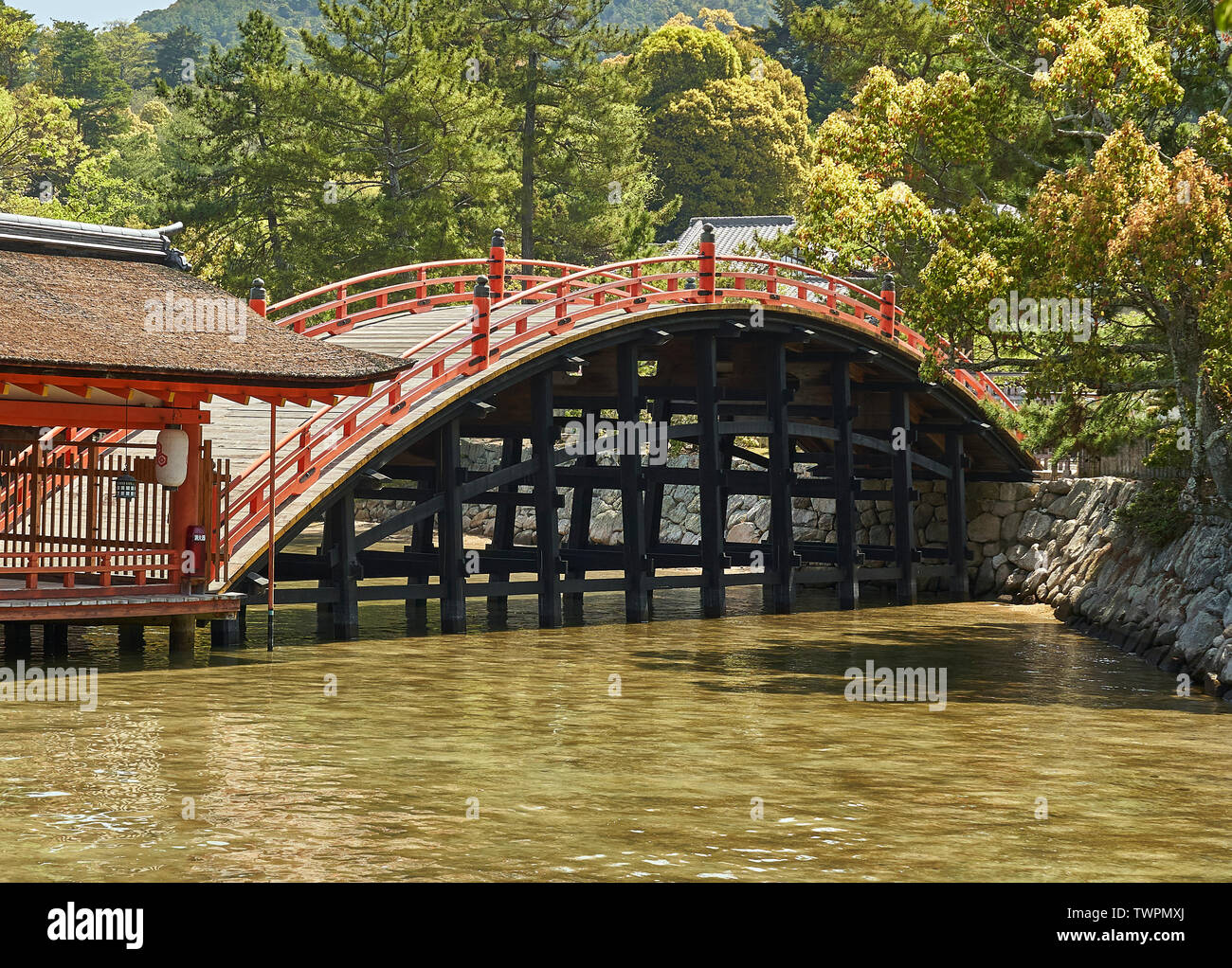 An orange and blacke colored bridge at the Itsukushima shrine Stock ...