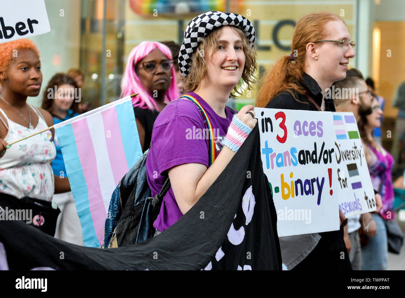 A protester holds a placard during the Trans march.Spectators displayed ...