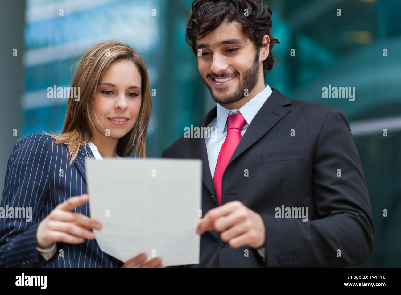 Business people reading a document Stock Photo - Alamy