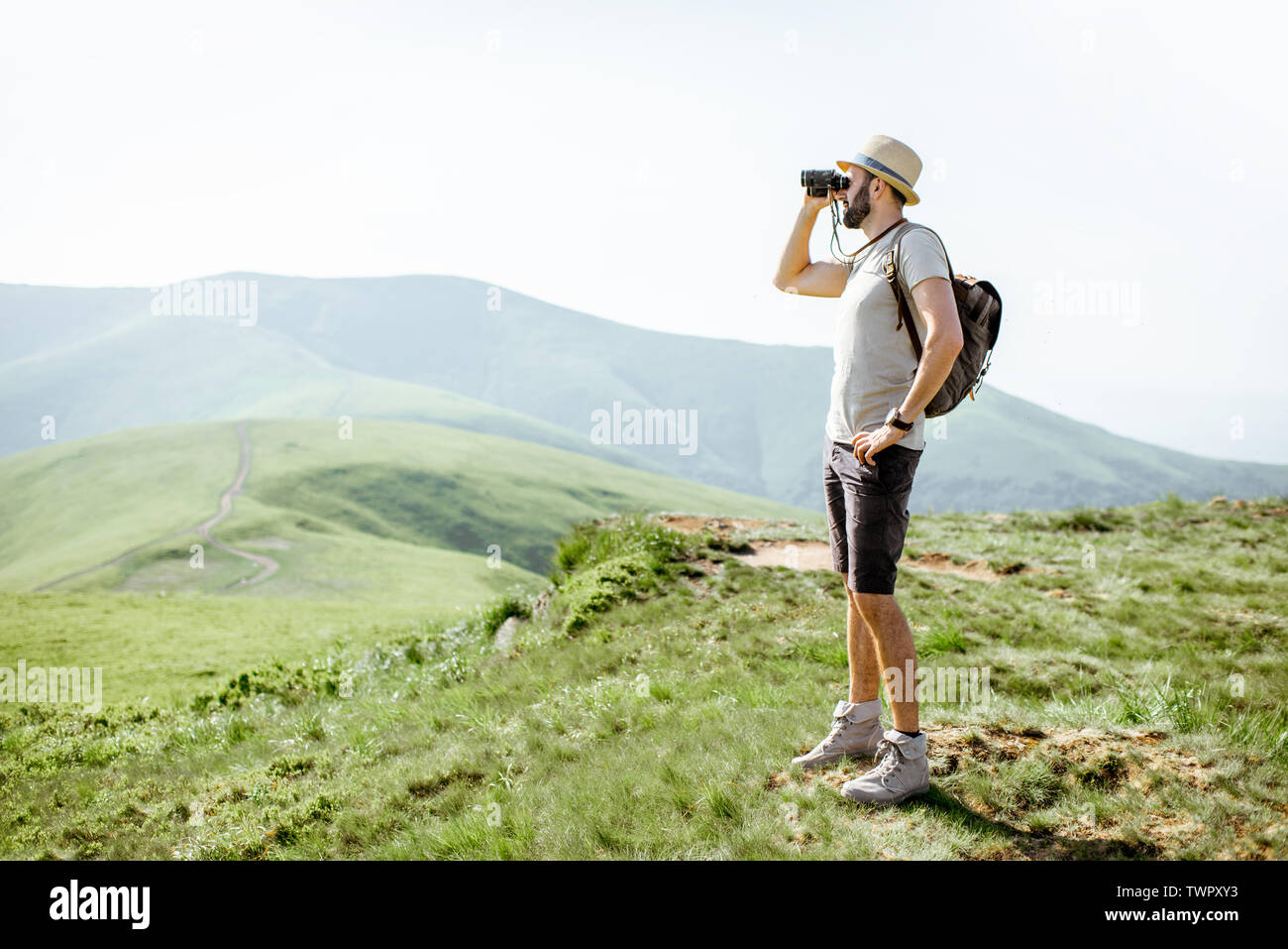 Man enjoying the beautiful views on the mountains, looking at the ...