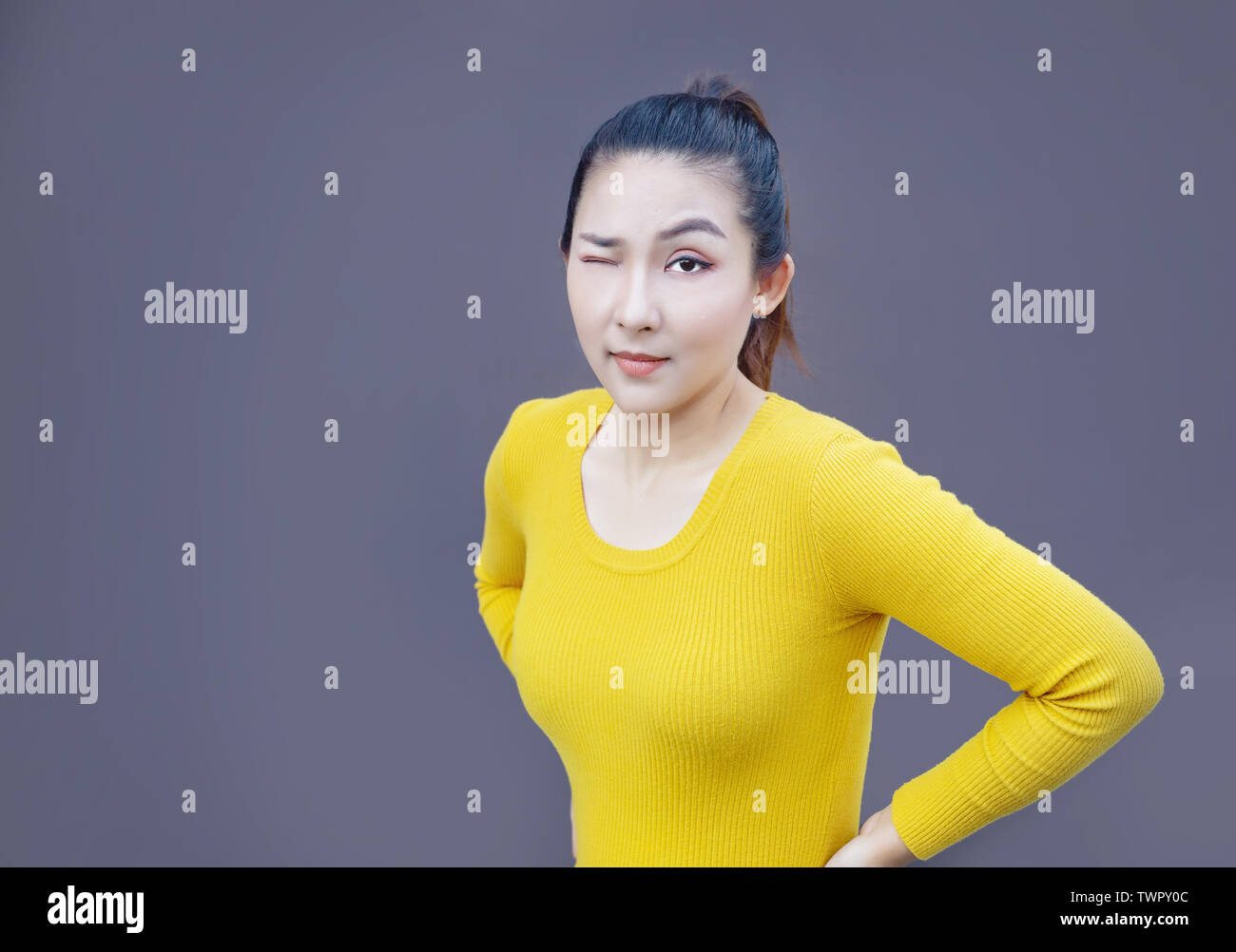 smart asian girl yellow dress portrait on dark background Stock Photo ...