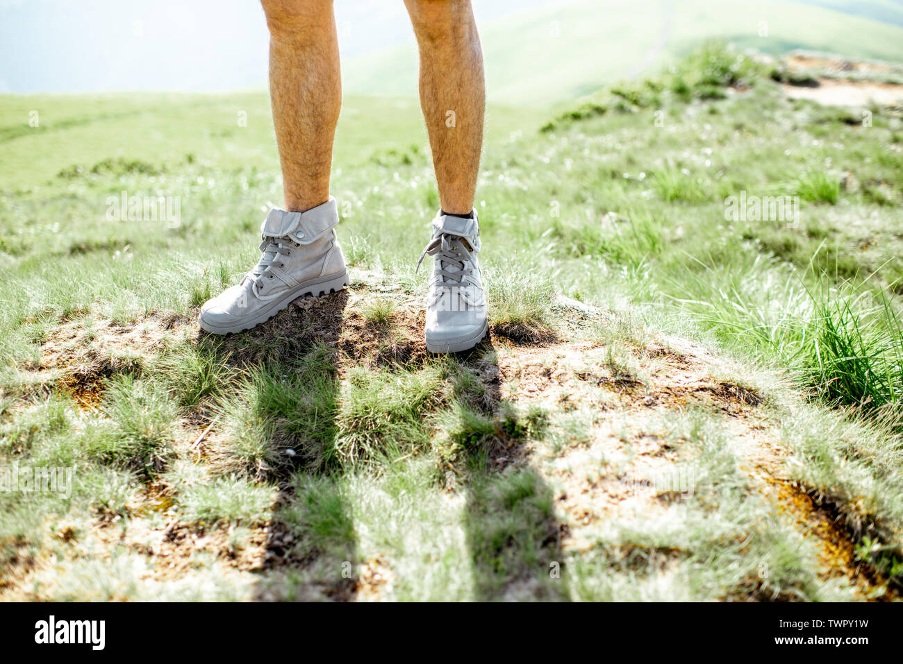 Close-up of a male legs in trekking shoes outdoors Stock Photo - Alamy