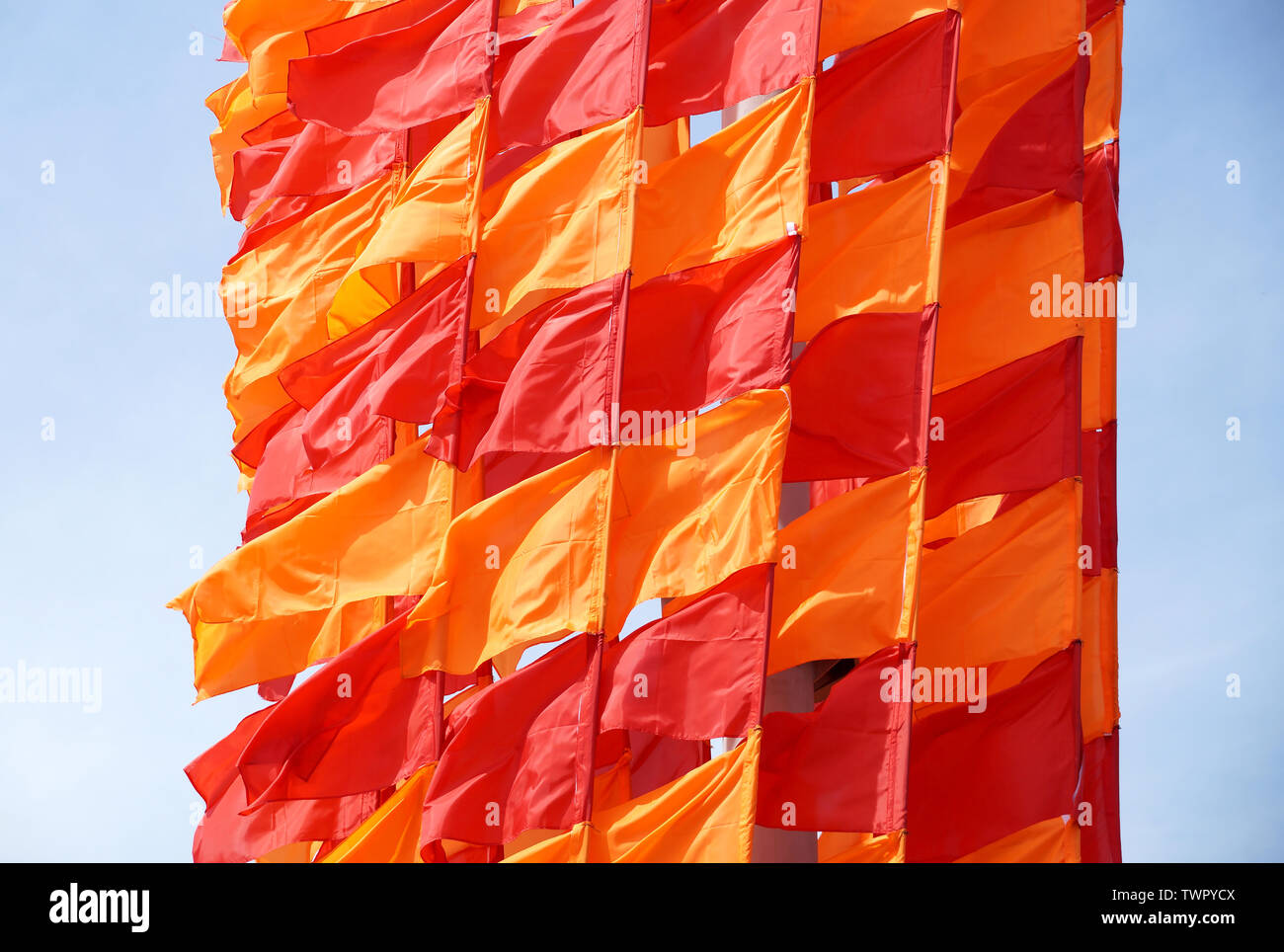 Festive flags of red and orange color on a flagstaff Stock Photo - Alamy
