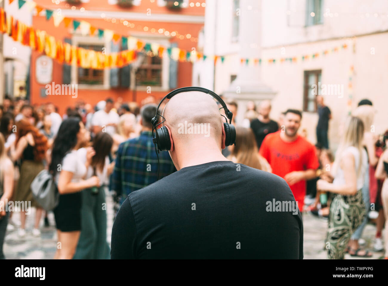Outdoor party, DJ and blurred people in the background. Festive summer ...
