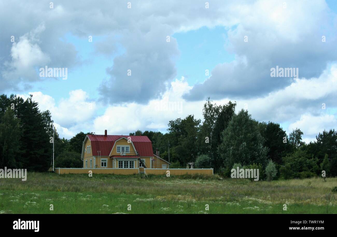 view of finnish countryside with a farm in a field Stock Photo - Alamy