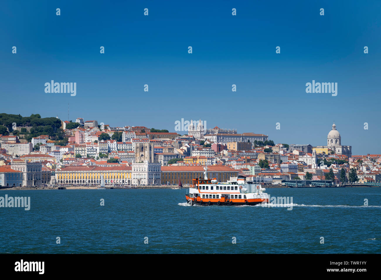 A traditional ferry boat (Cacilheiro) crossing the Tagus River with the ...