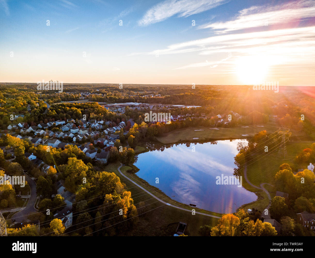 Aerial drone view of a neighborhood in North Charlotte at sunset with ...