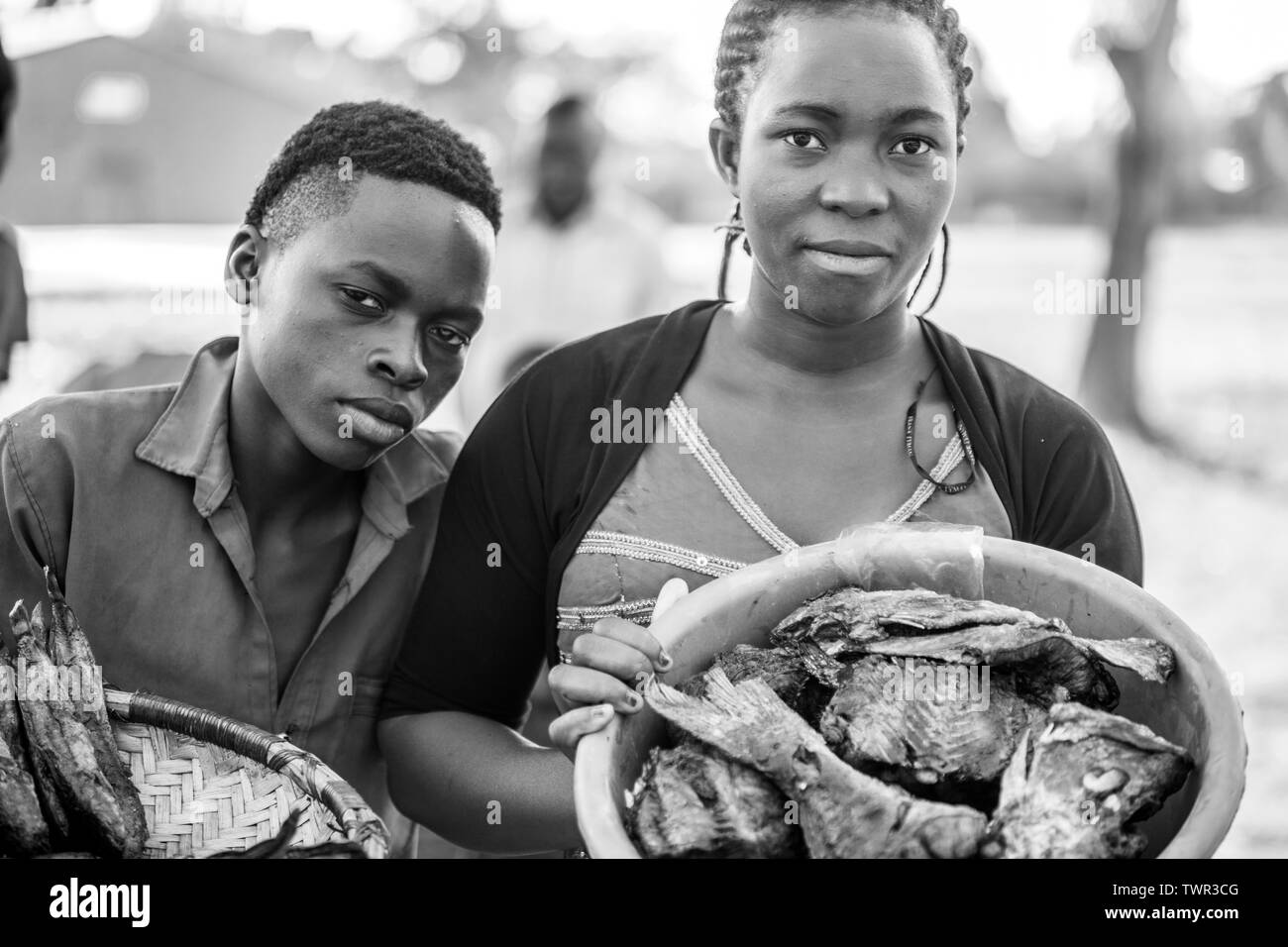 Child street vendors selling their Chambo fish Stock Photo - Alamy
