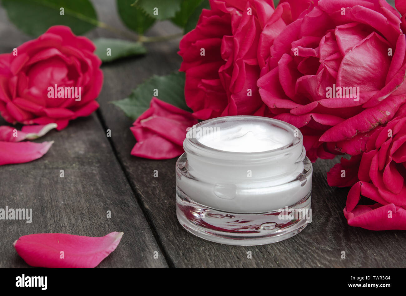 Natural flower cosmetics with red pink flowers for face and body care ...