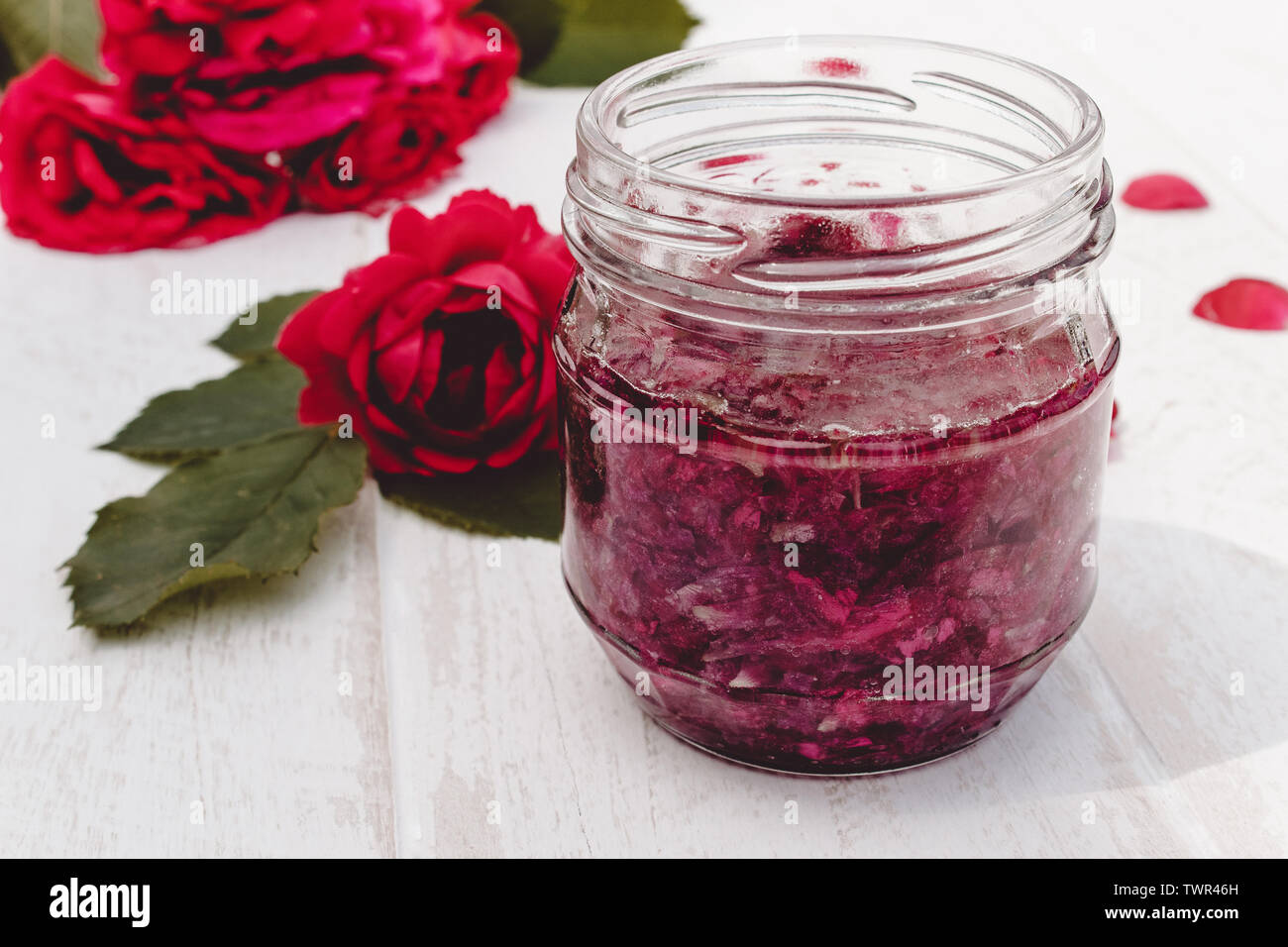 Jam of rose petals in a glass jar on a light background. Flower ...