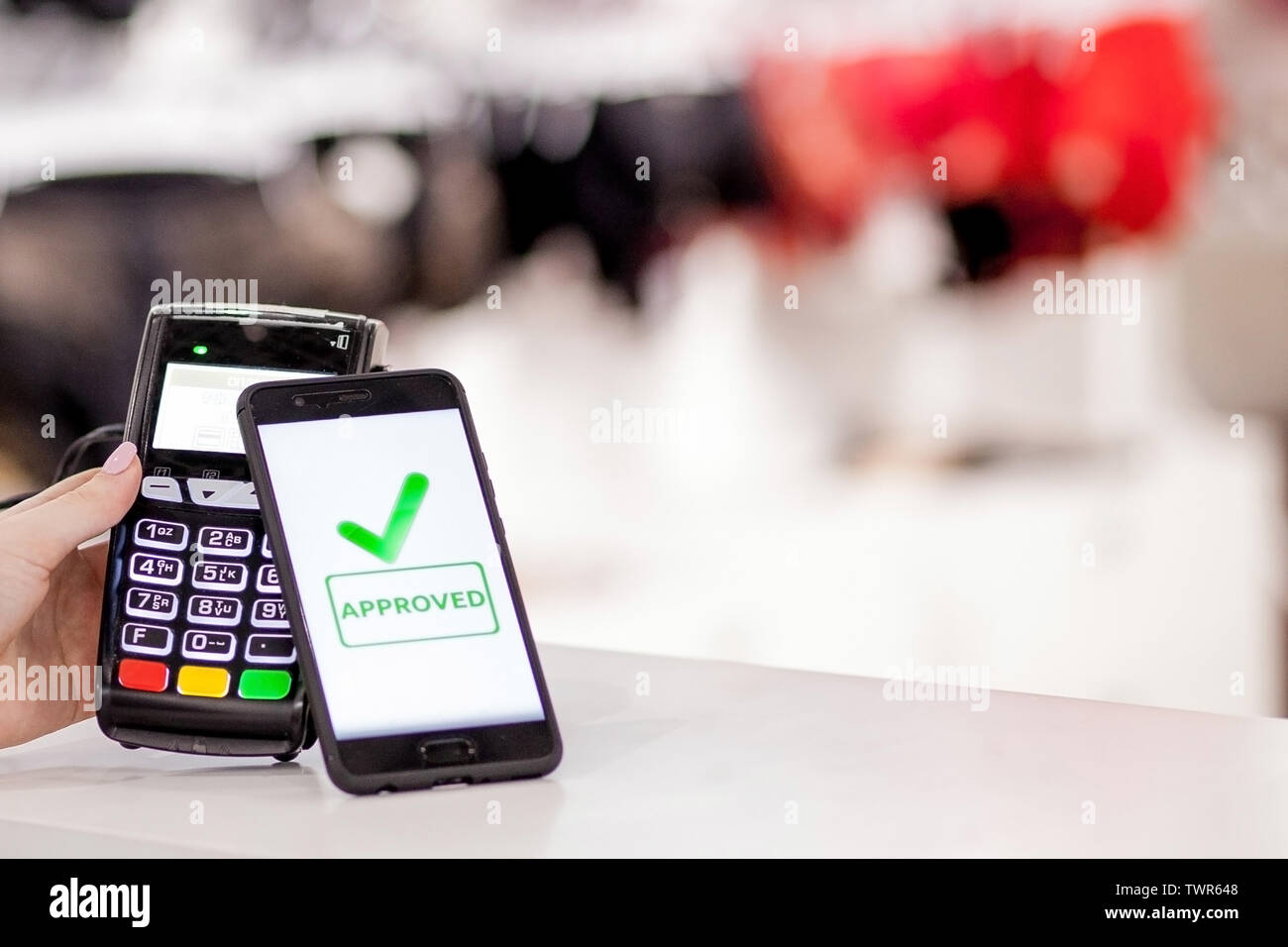 POS terminal, Payment Machine with mobile phone on store background ...