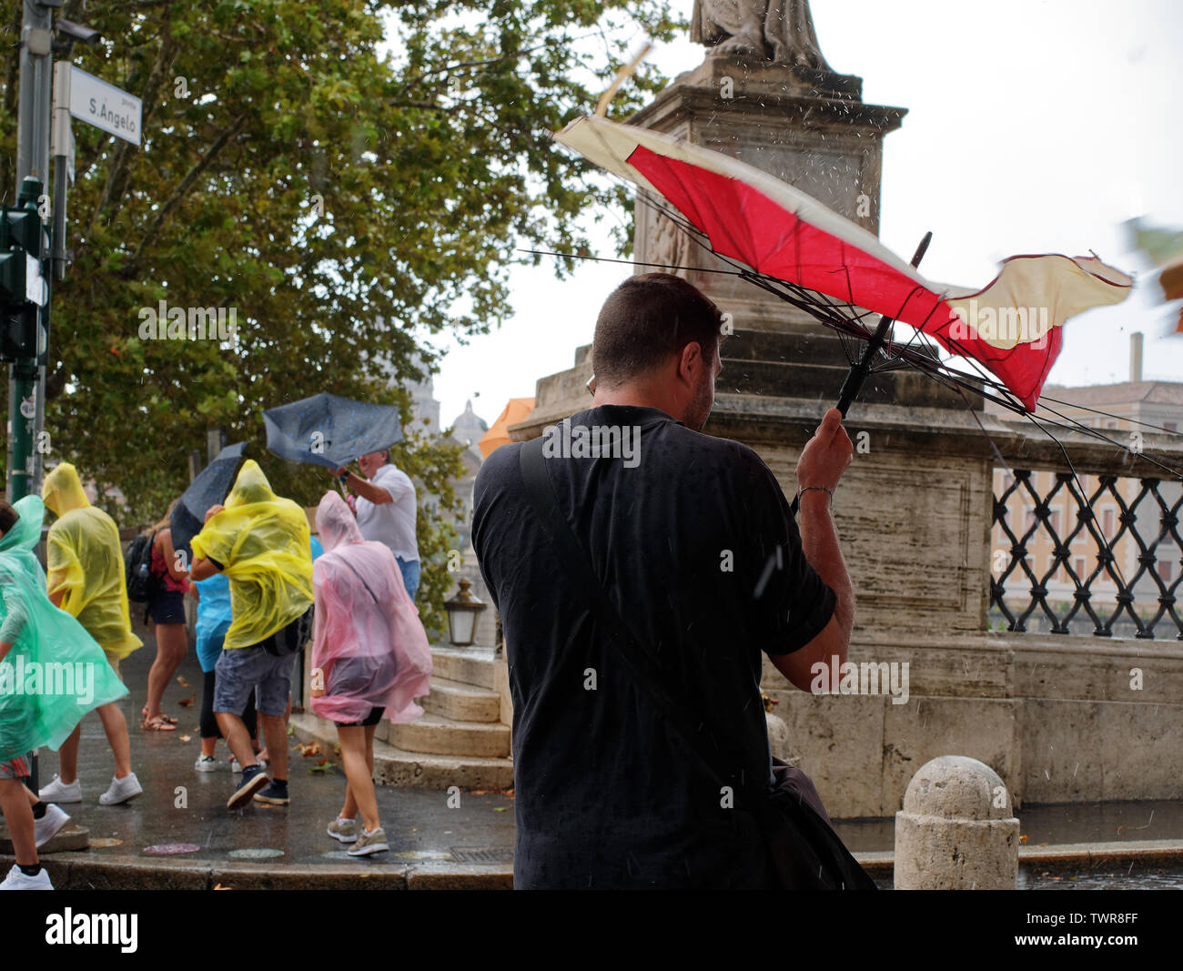 Tourists in Rome under heavy rain and strong wind in summer Stock Photo ...