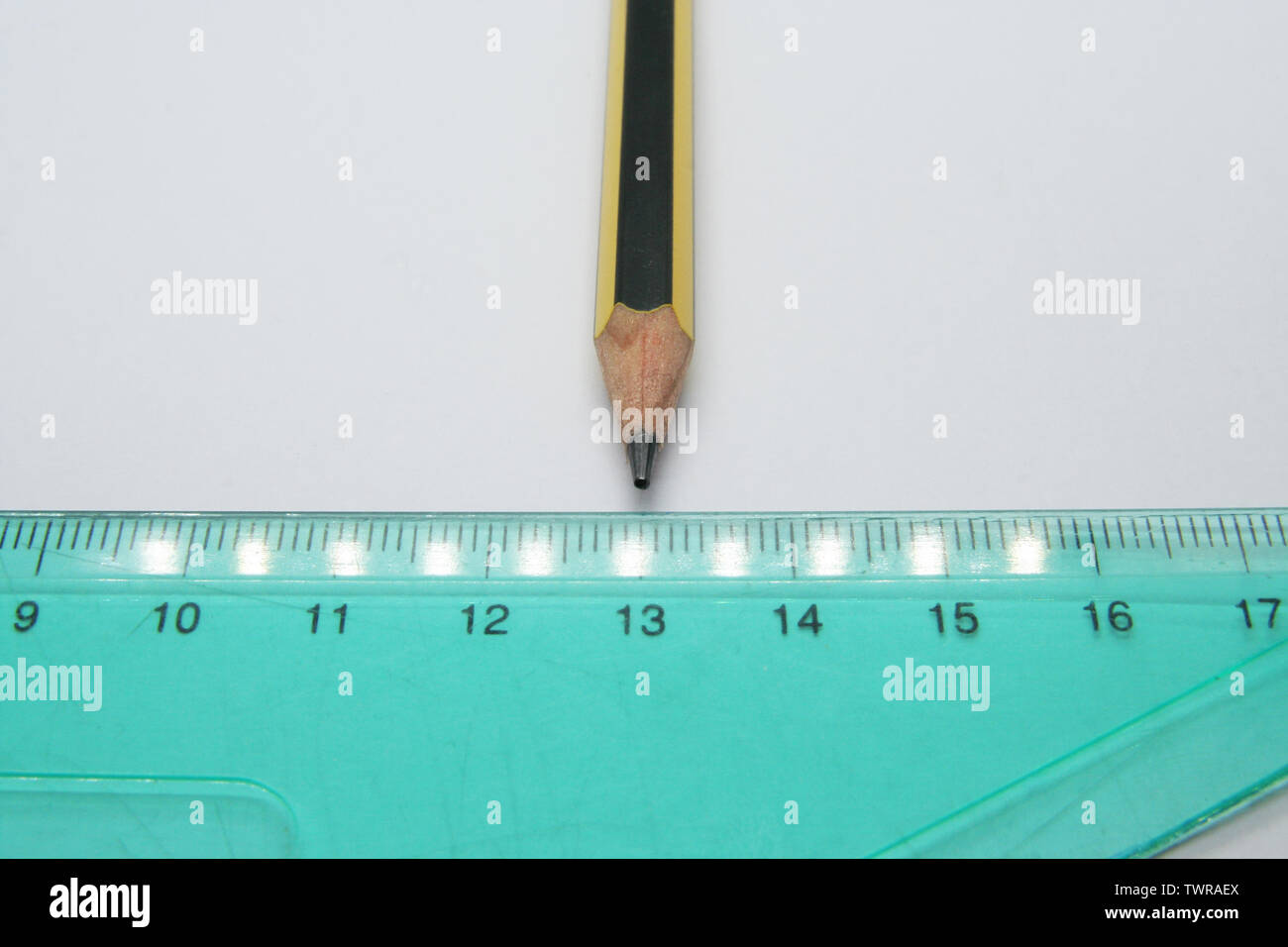 Old used triangle ruler and a pencil. Ruler and pencil Stock Photo - Alamy