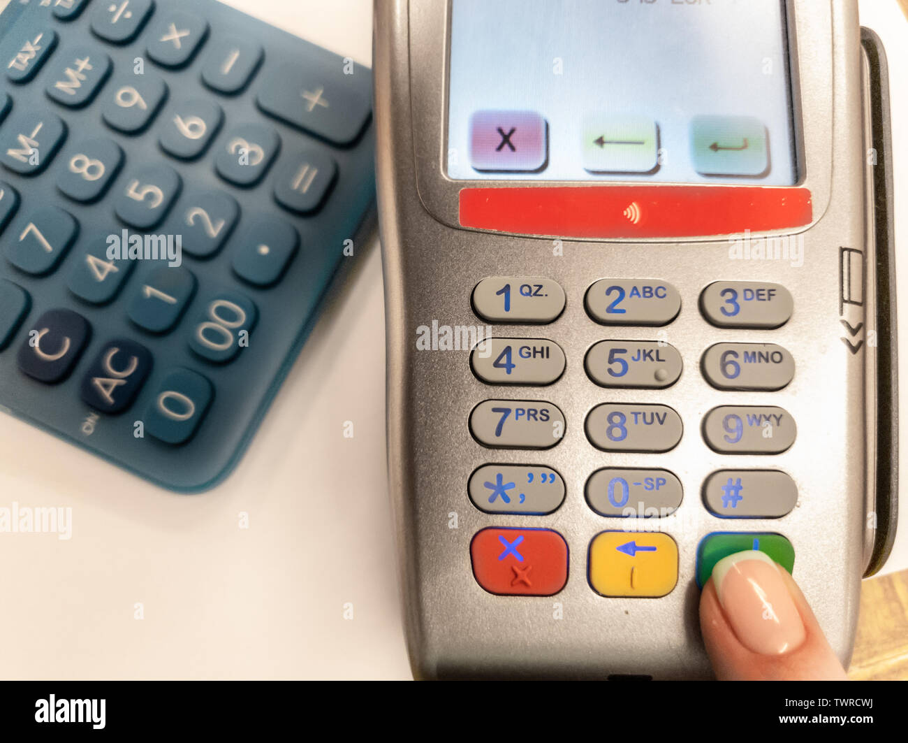 Woman pressing green button on a silver payment machine. Closeup of ...