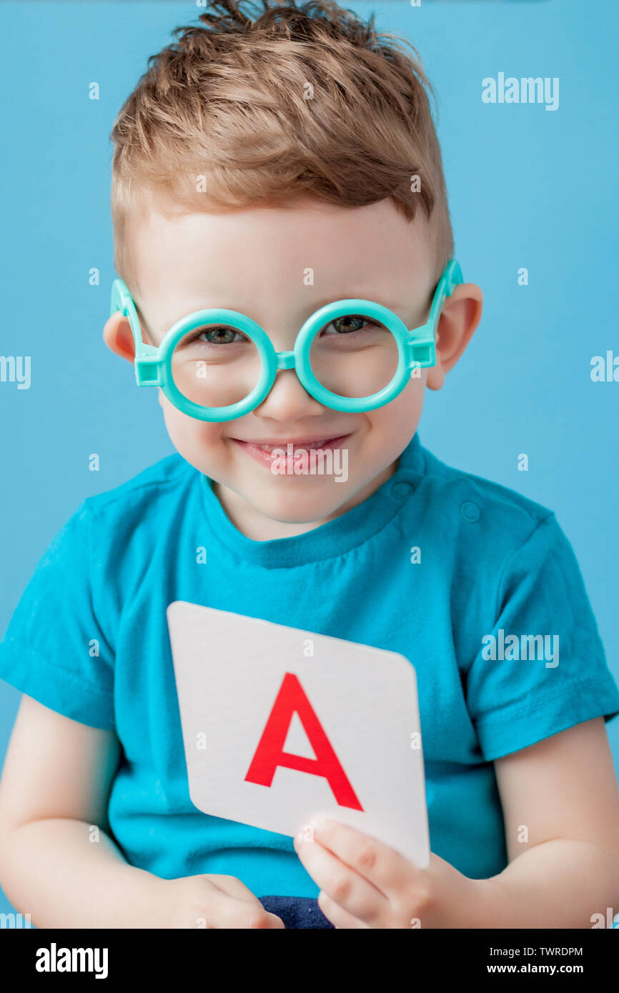 Cute Little Boy With Letter On Background Child Learn Letters cute-little-boy-with-letter-on-background-child-learn-letters