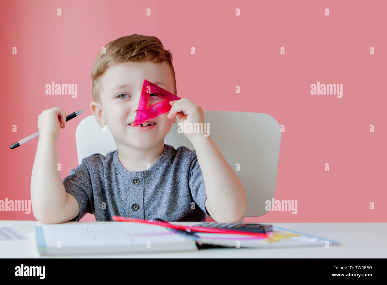 Portrait of cute kid boy at home making homework. Little concentrated ...
