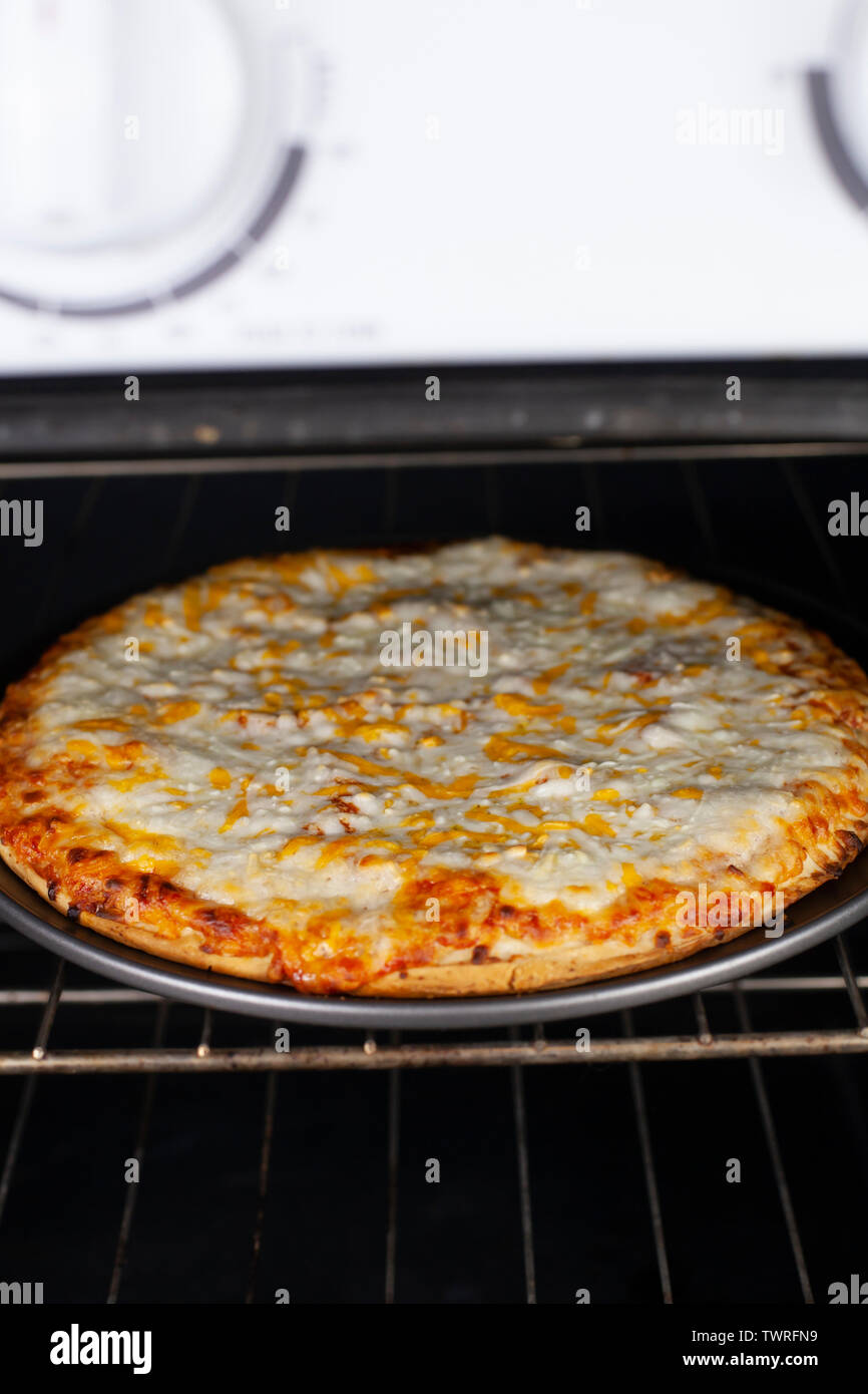 Cooked cheese pizza ready to be pulled out in the oven Stock Photo - Alamy