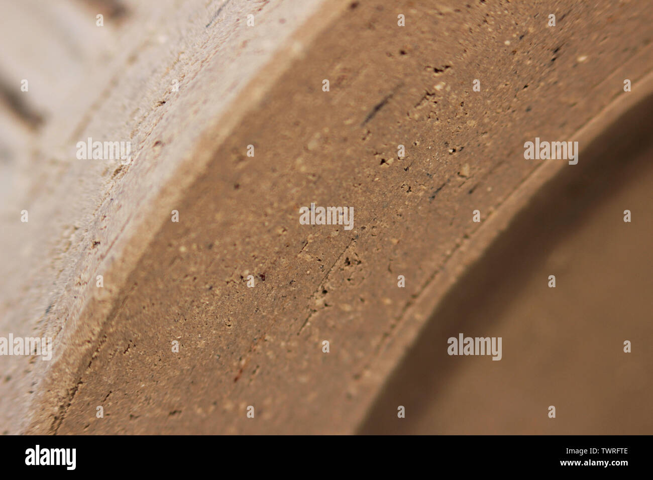 the smooth, equal turned round bottom of a red clay pot with stripes ...