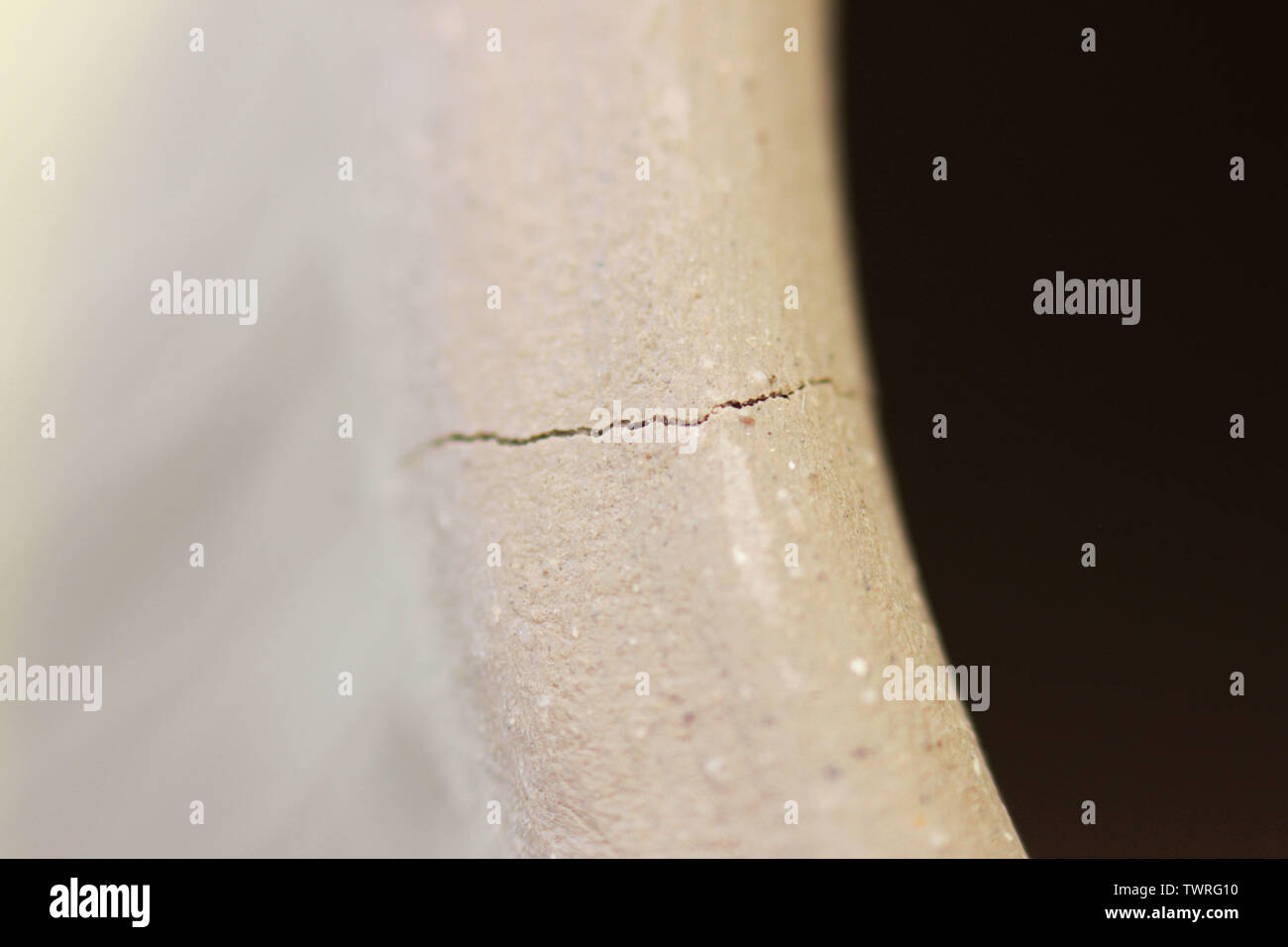 top edge of a red clay pot with crack due to fast drying and too deep ...