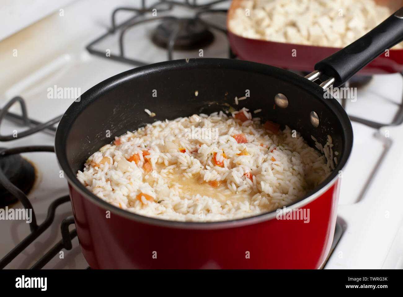 Spicy rice simmering in a large cooking pot Stock Photo - Alamy