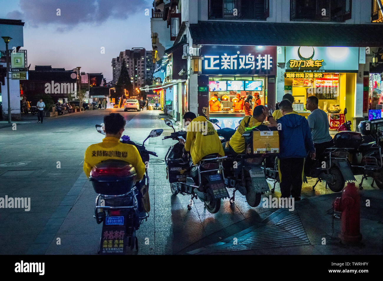 Delivery food workers wait in front of the restaurant in the old water ...
