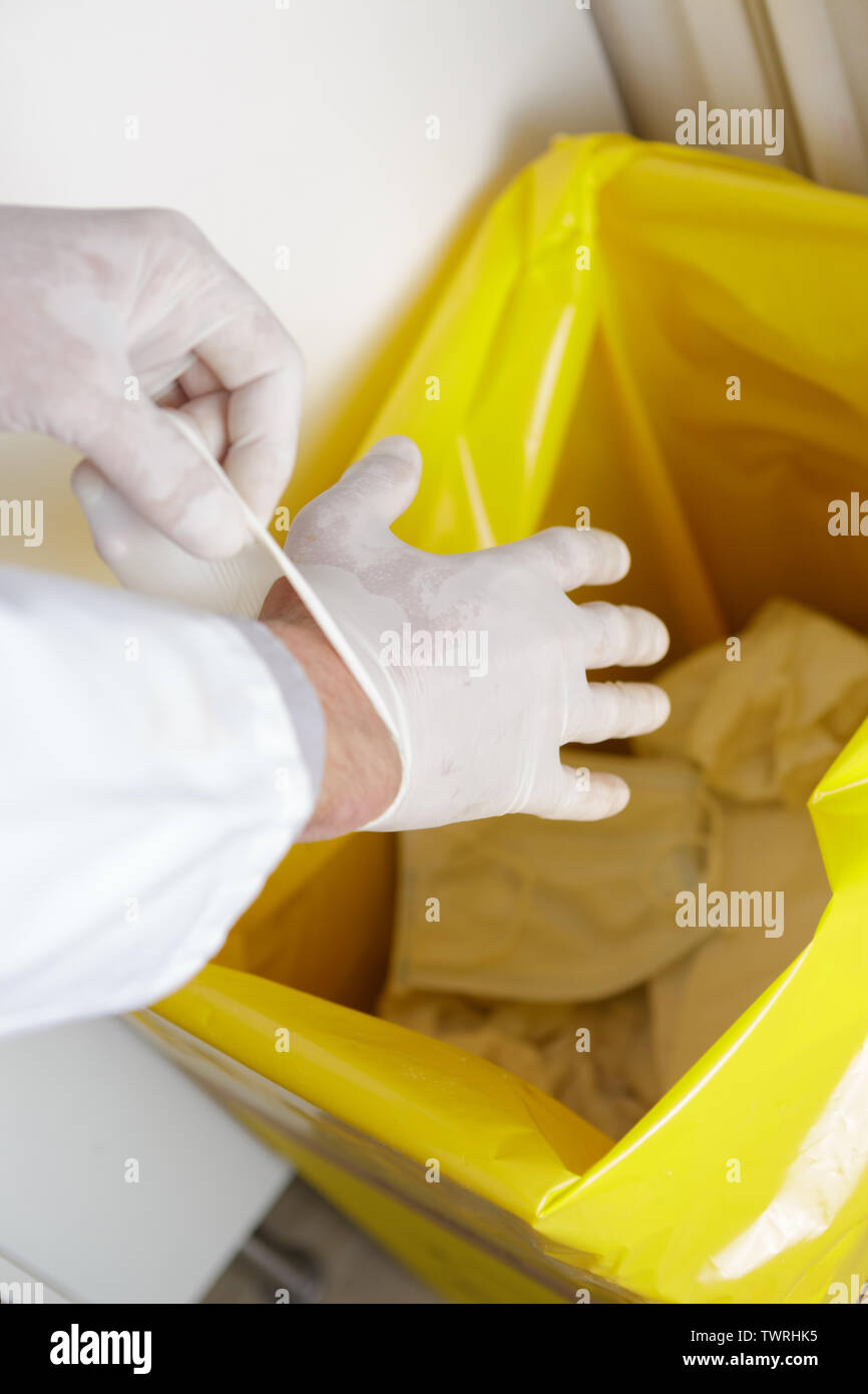surgeon trowing surgical gloves used in trash bin Stock Photo - Alamy