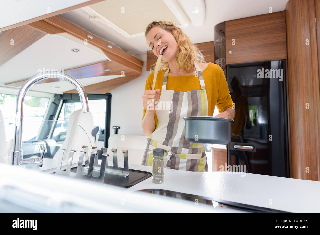 woman singing while cooking inside motorhome Stock Photo - Alamy