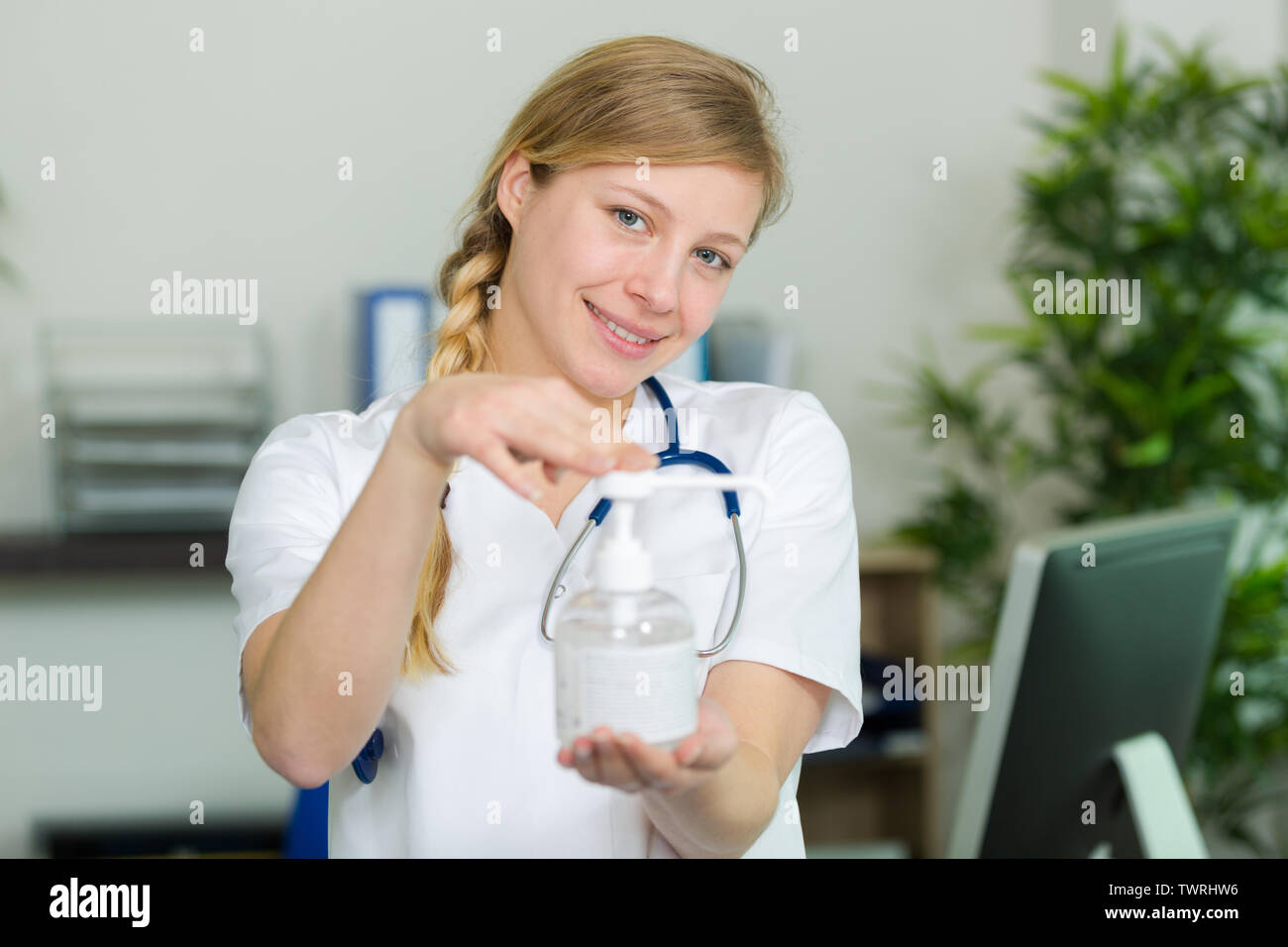 female nurse holding pump dispenser of antibacterial handwash Stock ...