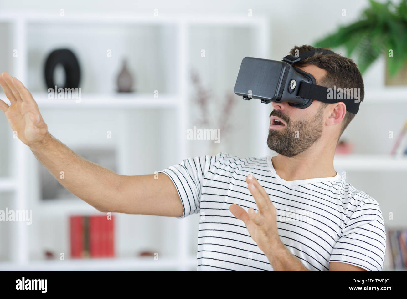 happy man using vr glasses inside the virtual reality mode Stock Photo - Alamy