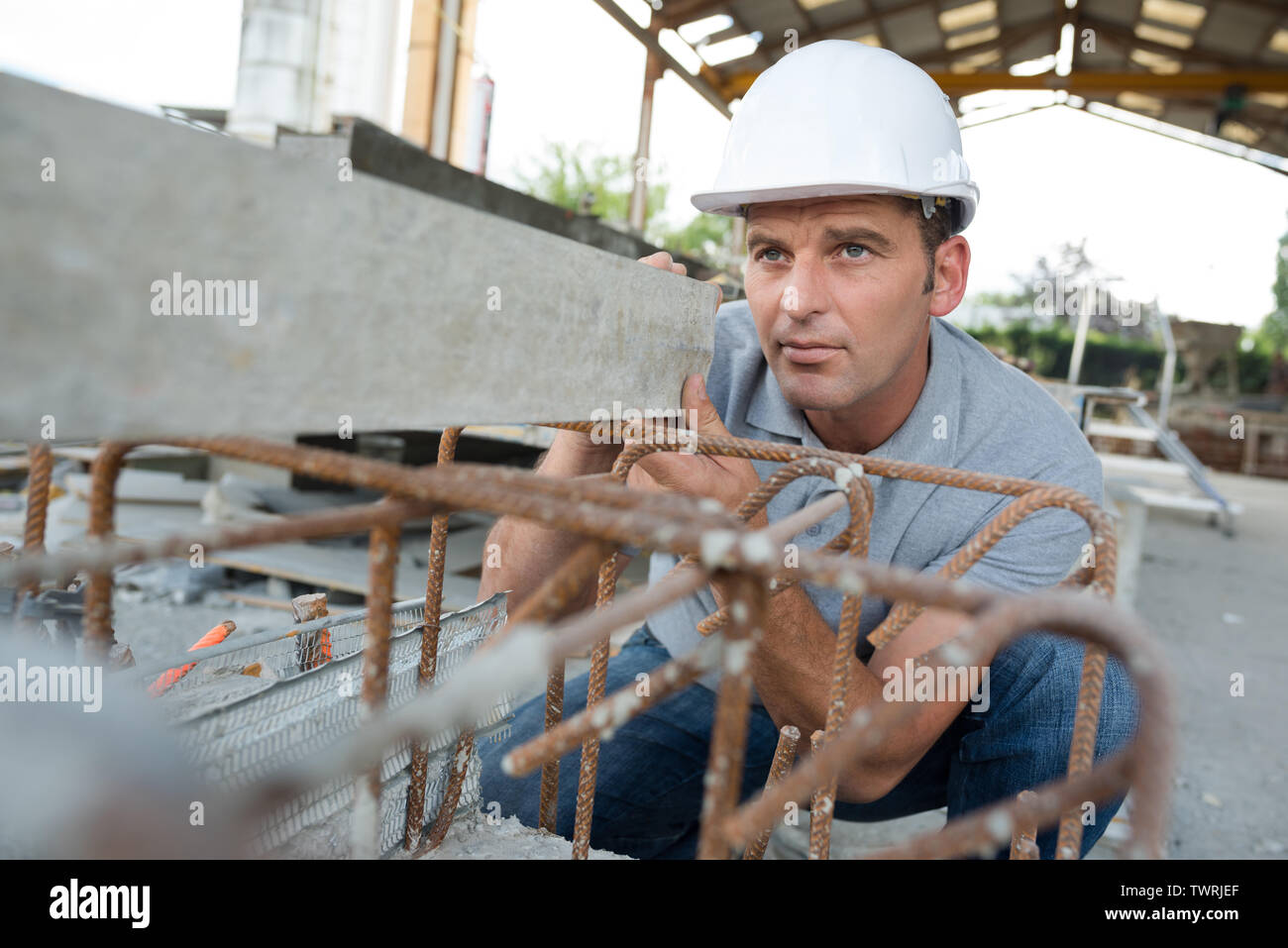 tradesman testing level of reinforcement bars Stock Photo - Alamy