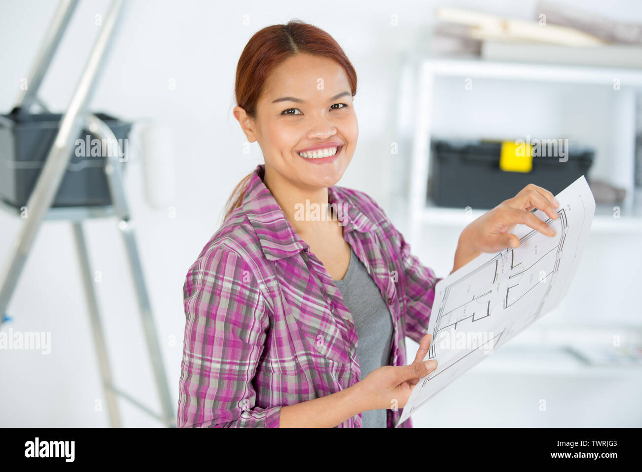 interior designer holding plans Stock Photo - Alamy