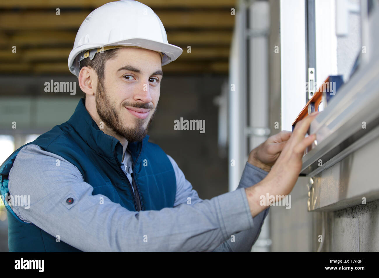 workman measuring window frame Stock Photo - Alamy
