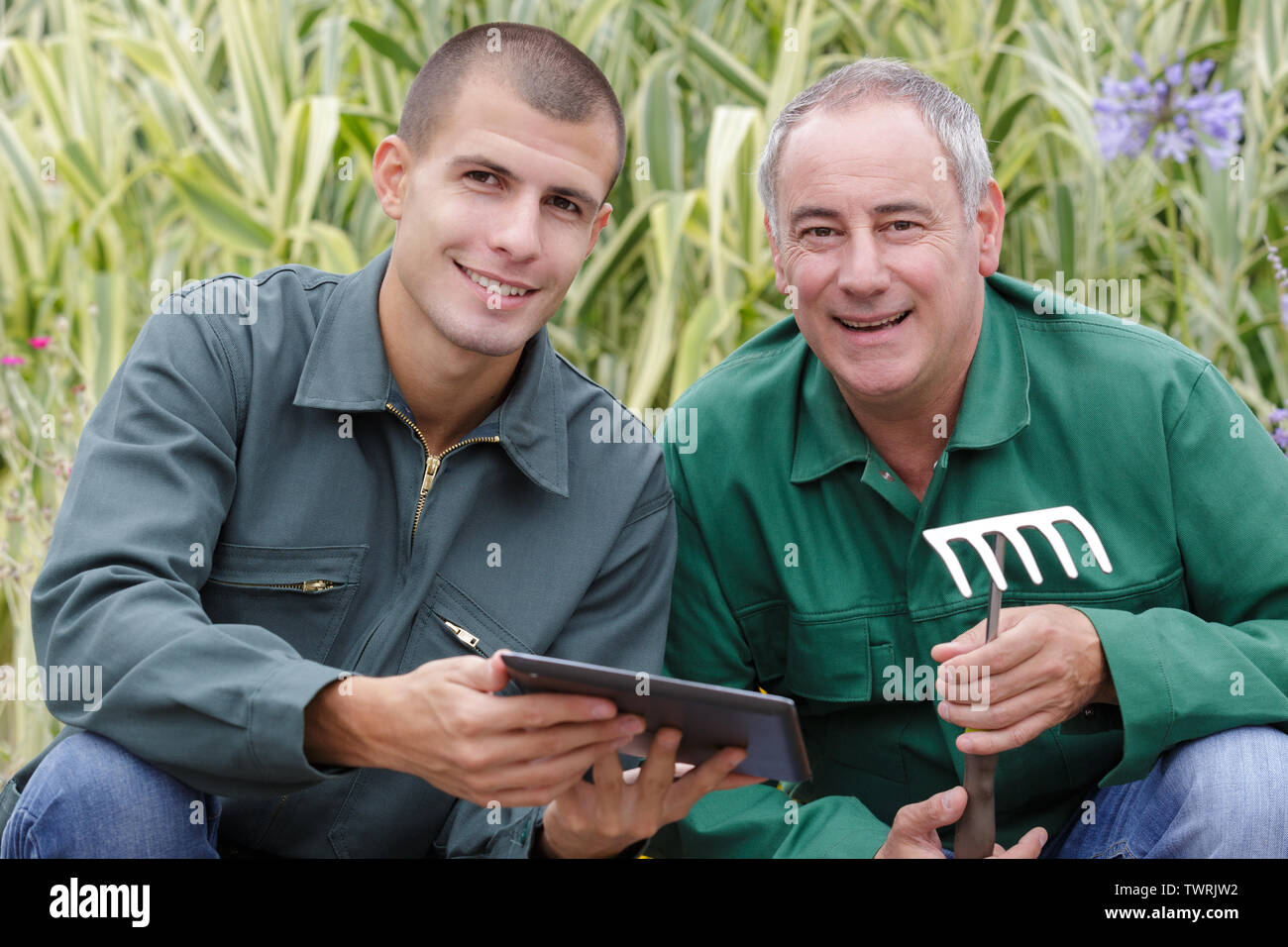 gardeners holding tablet Stock Photo - Alamy