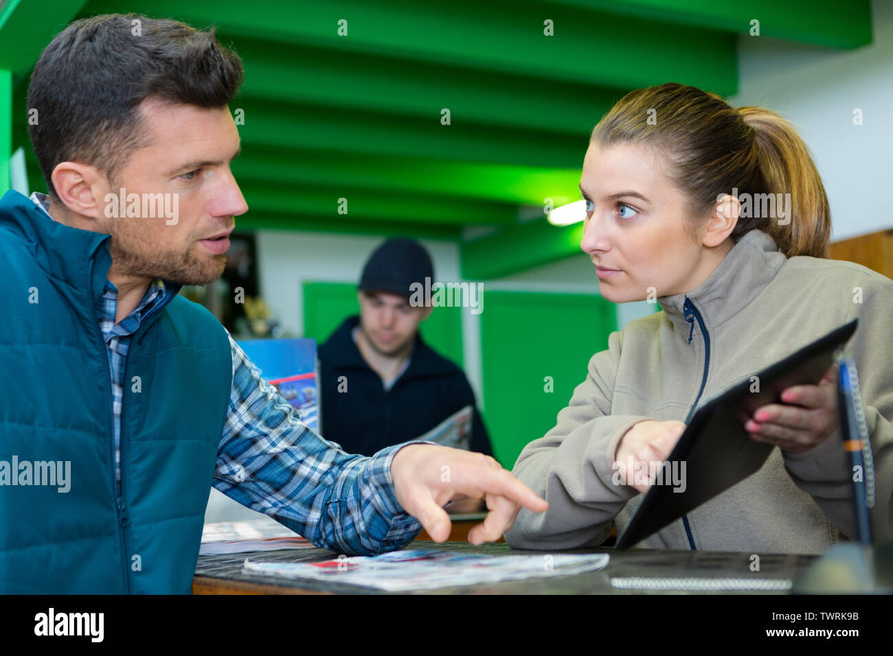 retailer helping customer with a problem Stock Photo - Alamy
