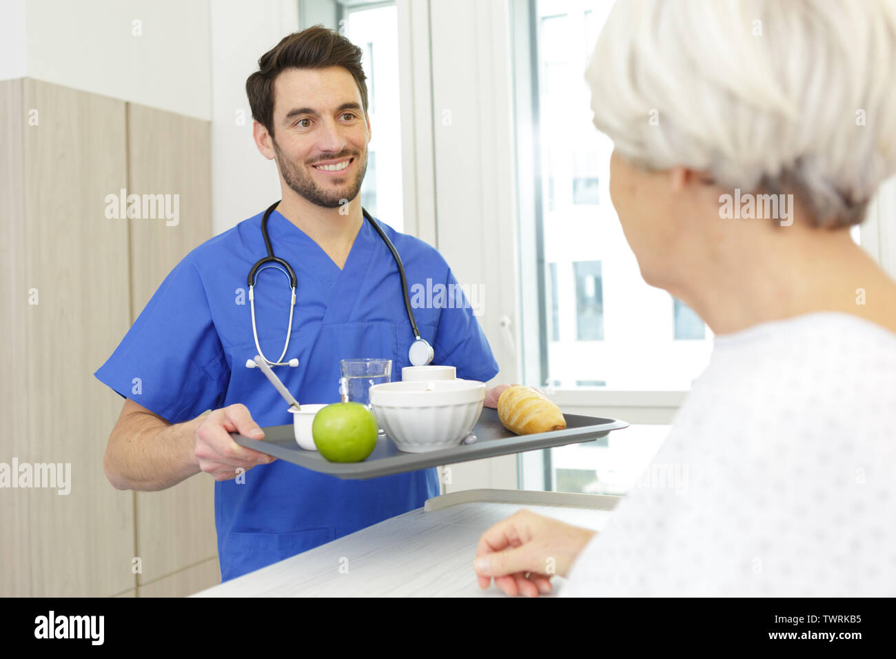 nurse serving a breakfast to patient in hospital Stock Photo - Alamy