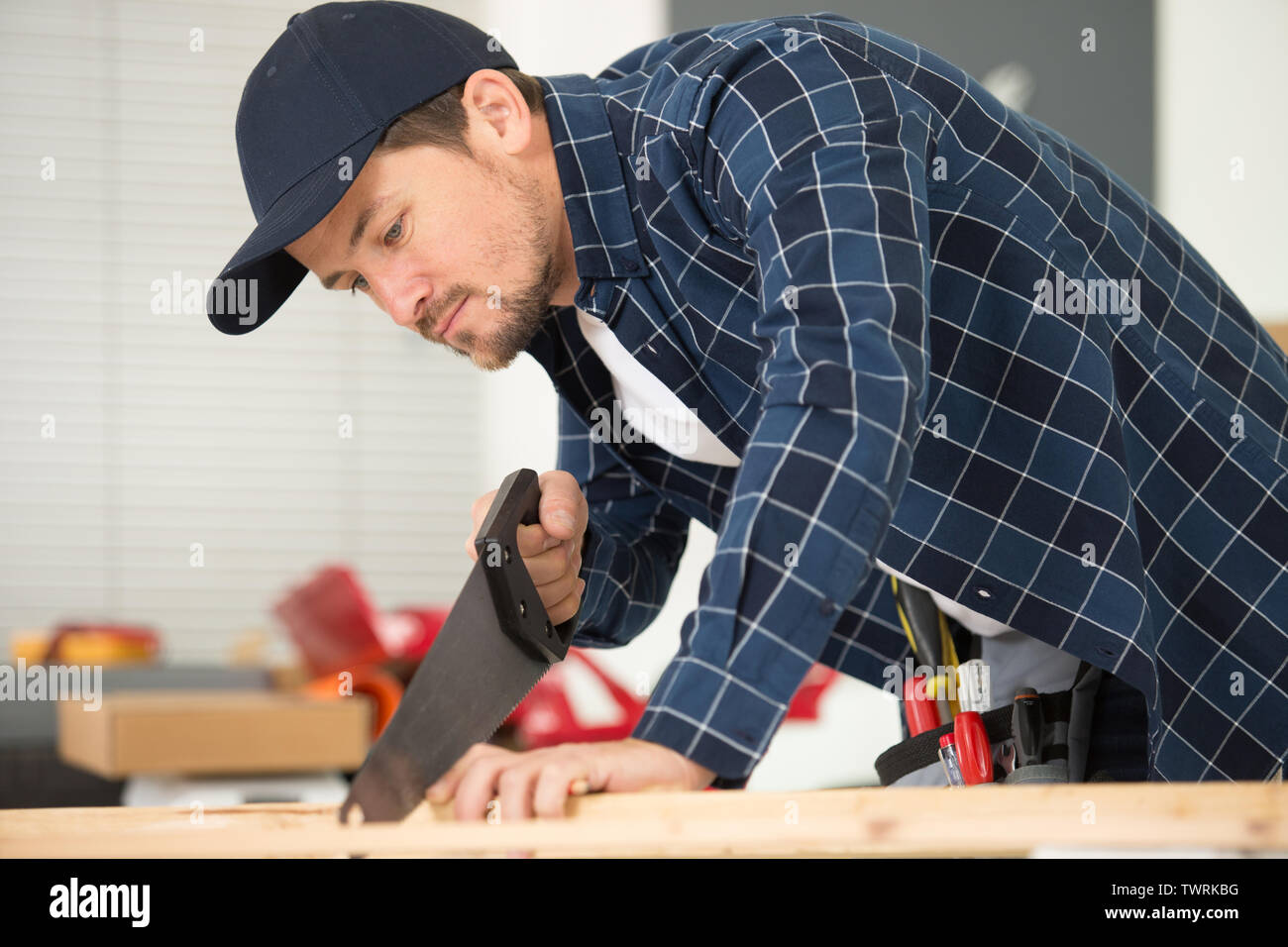 man sawing wood saw Stock Photo - Alamy