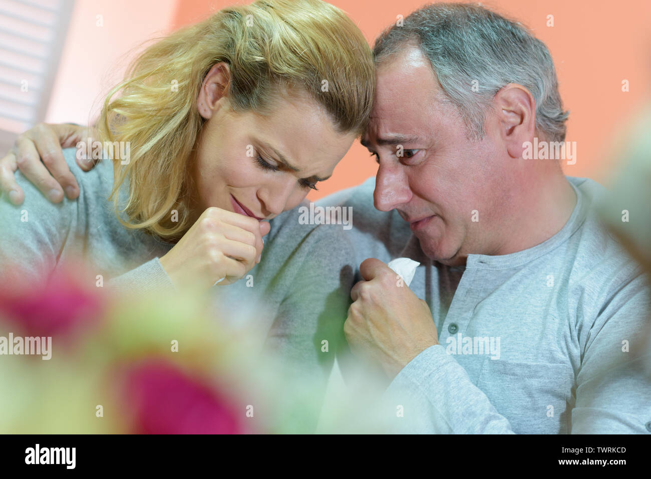 two sad people who cuddle in a cemetery Stock Photo - Alamy