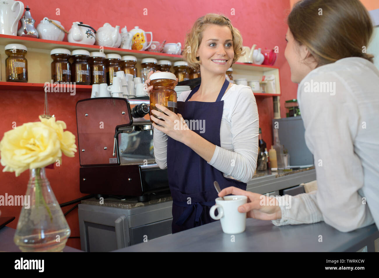 young female barista serving coffee to customer in cafe Stock Photo - Alamy