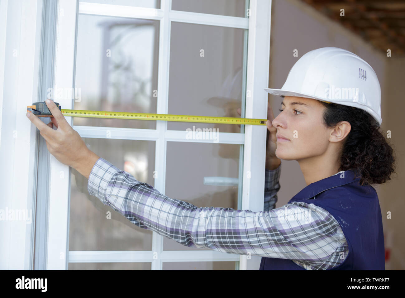 woman measuring window frame Stock Photo - Alamy