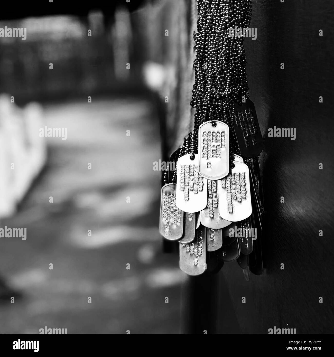 A collection of dog tags from fallen Vietnam war soldiers hanging from ...