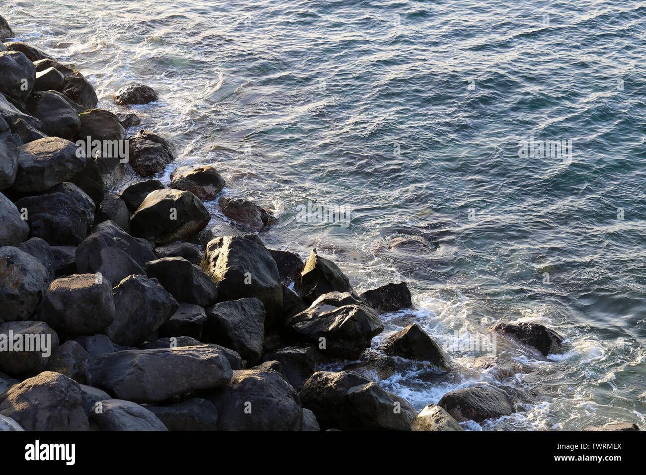 Small waves hitting rocks at a beach located in Madeira, Portugal ...
